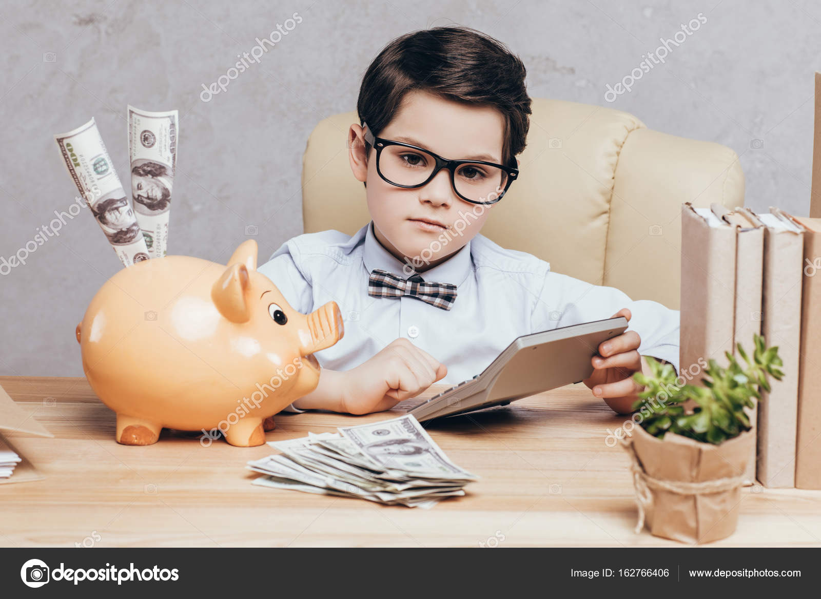 Kid using calculator at workplace — Stock Photo © VikaOvcharenko #162766406