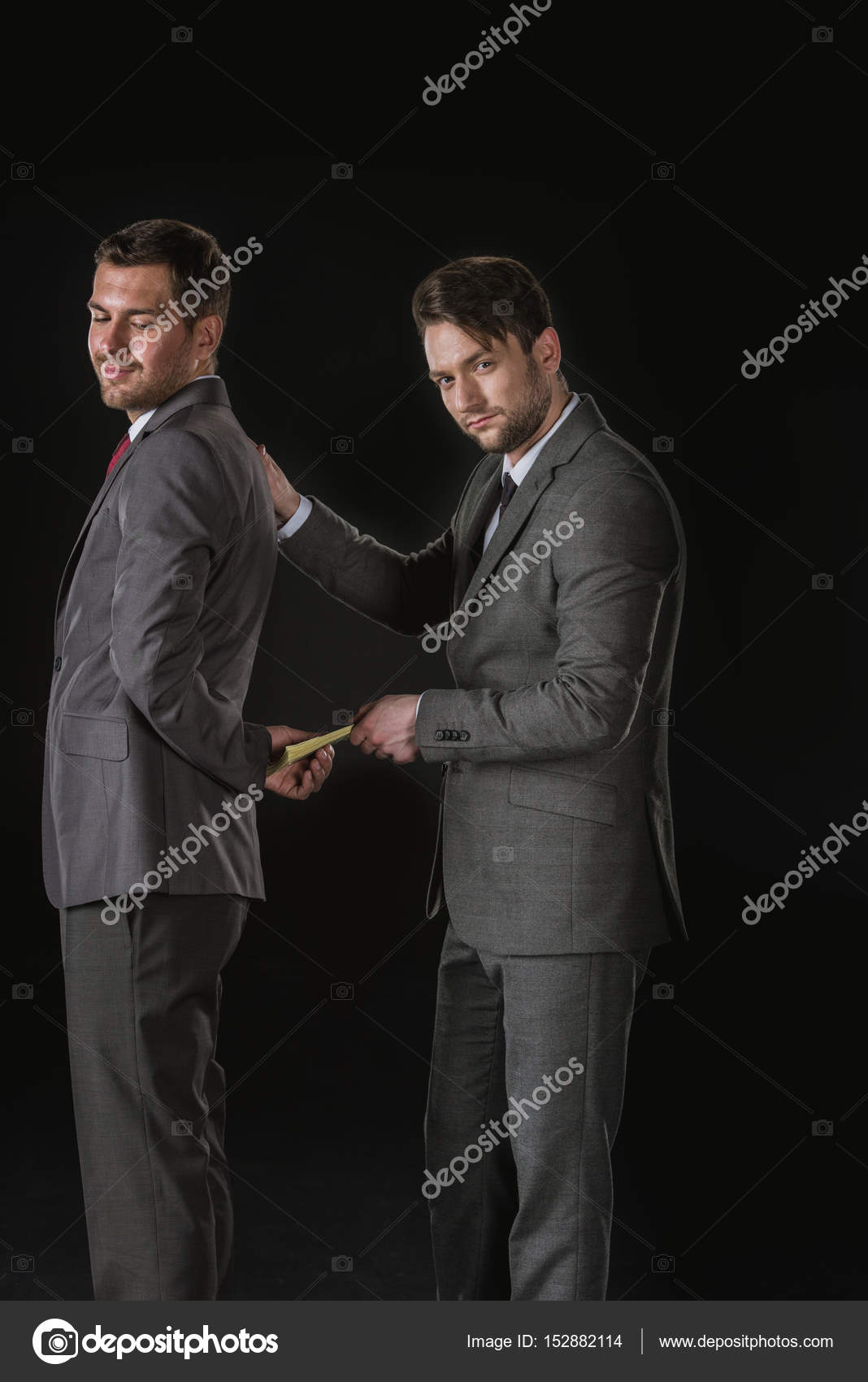 Businessman bribing partner — Stock Photo © SergPoznanskiy #152882114