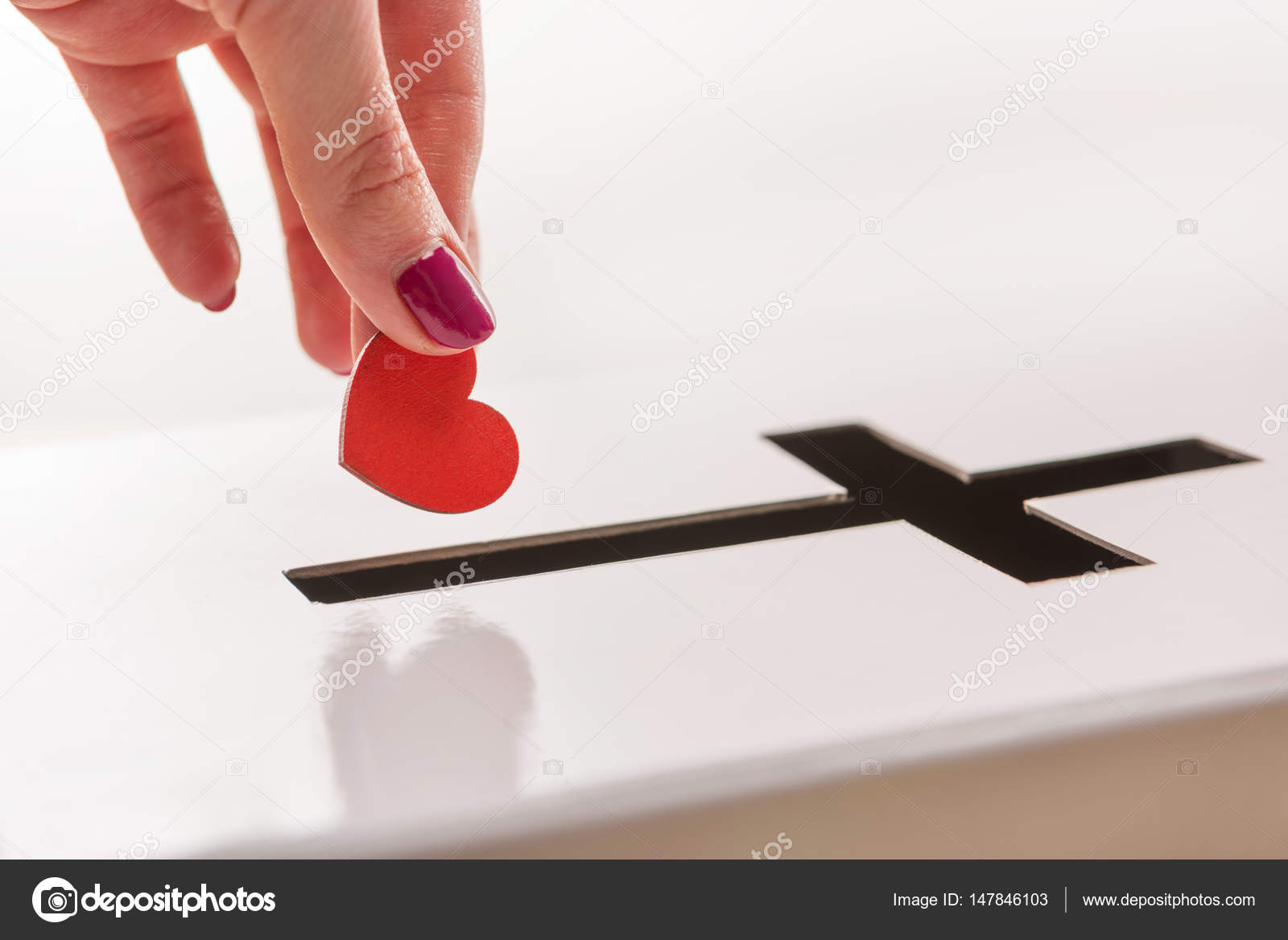 Hand inserting heart into hole for donations — Stock Photo ... Hand inserting heart into hole for donations — Stock Photo ...
