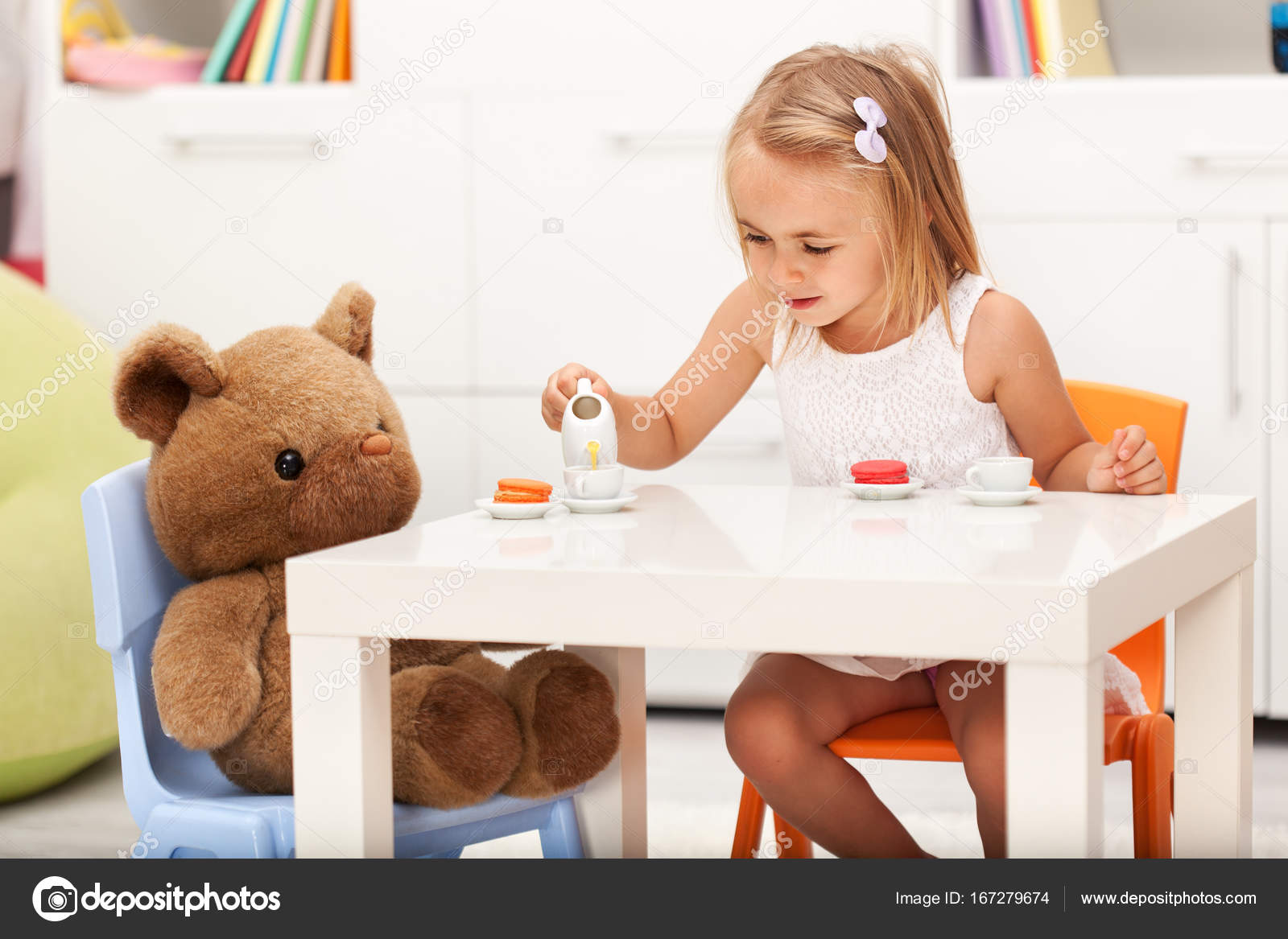 Little girl playing with her toy bear - having a tea party Stock Photo ...
