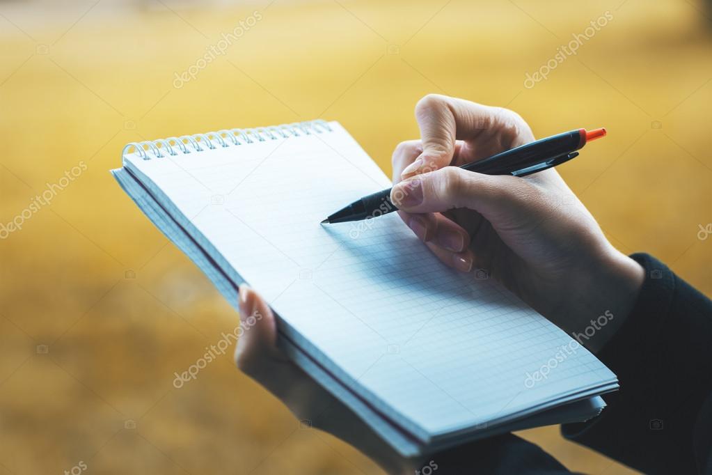 Female hands writing in notepad side — Stock Photo © peshkova #125049306