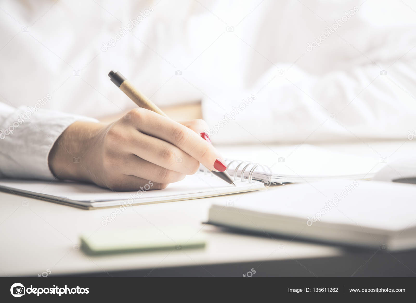 Lady writing in notepad Stock Photo by ©peshkova 135611262