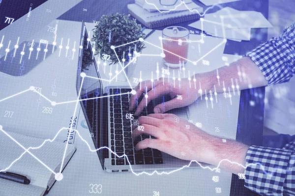 Double exposure of graph with man typing on computer in office on ...