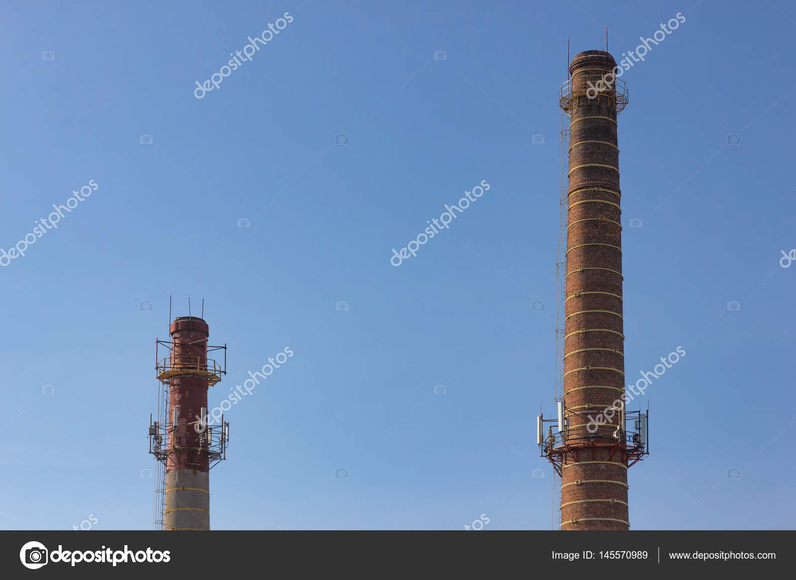 Old tower and pipe production on the background of blue sky — Stock ...