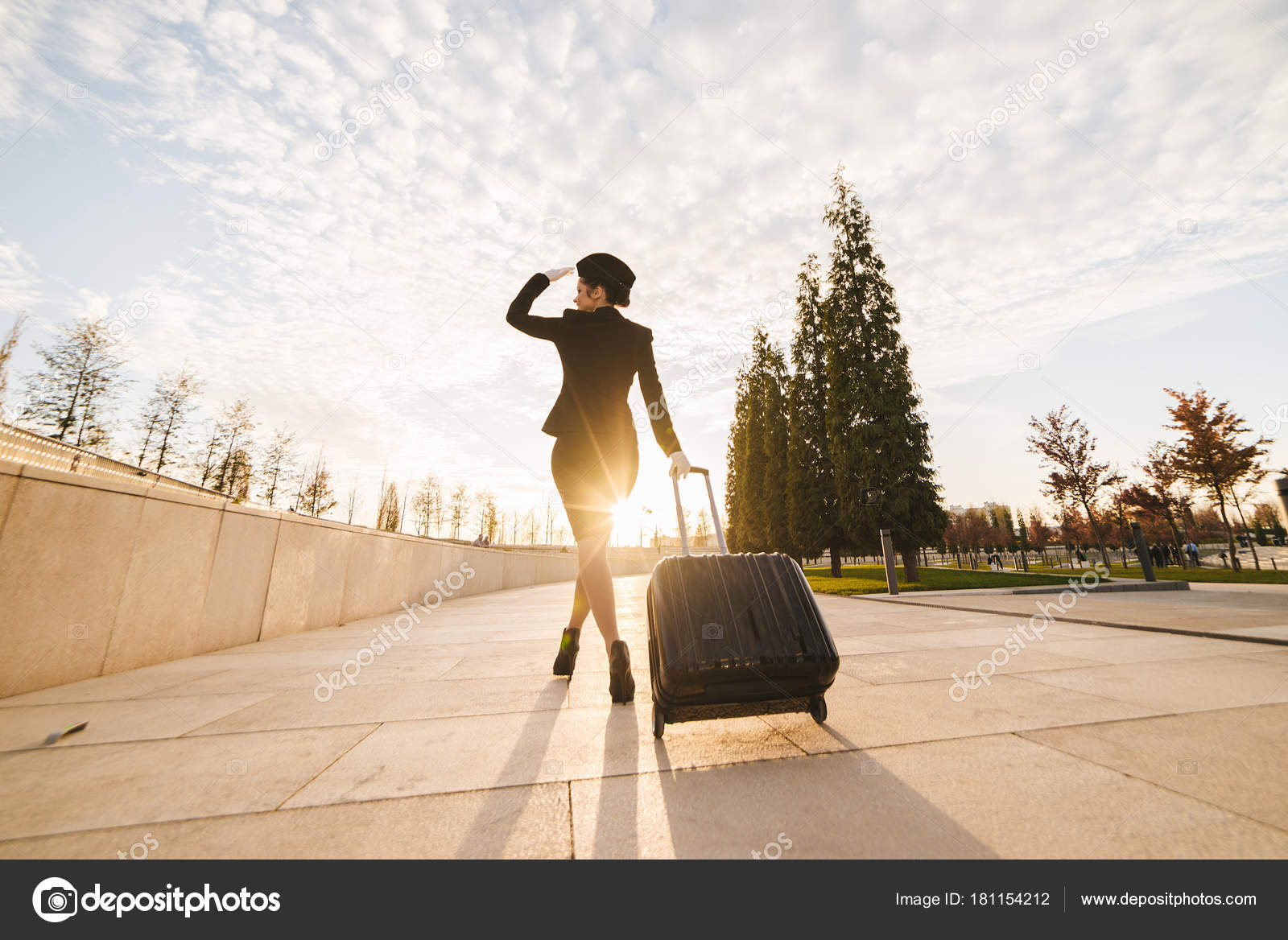 Stewardess in the uniform carries a large suitcase Stock Photo by ©mne ...