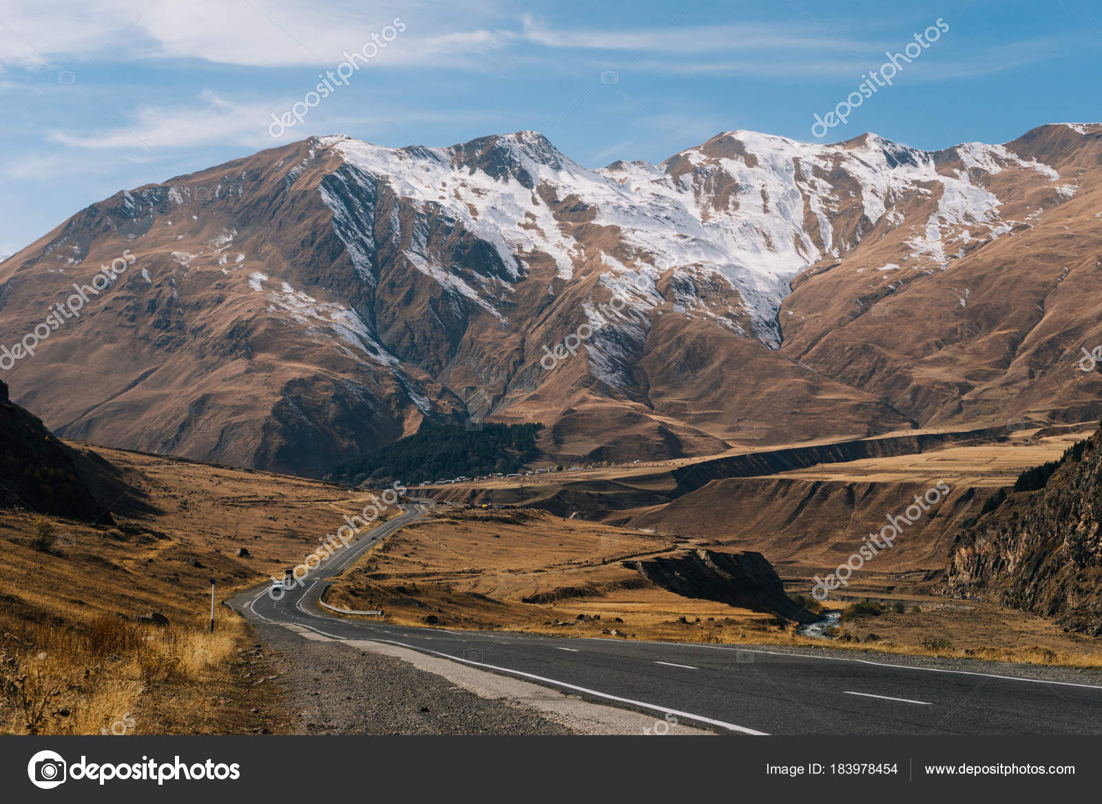 High mountains in the snow, straight road Stock Photo by ©mne_len 183978454