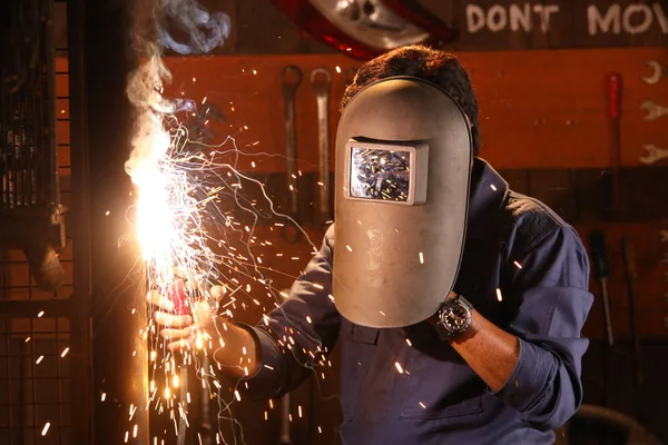 Man welding in shed - Stock Image - Everypixel