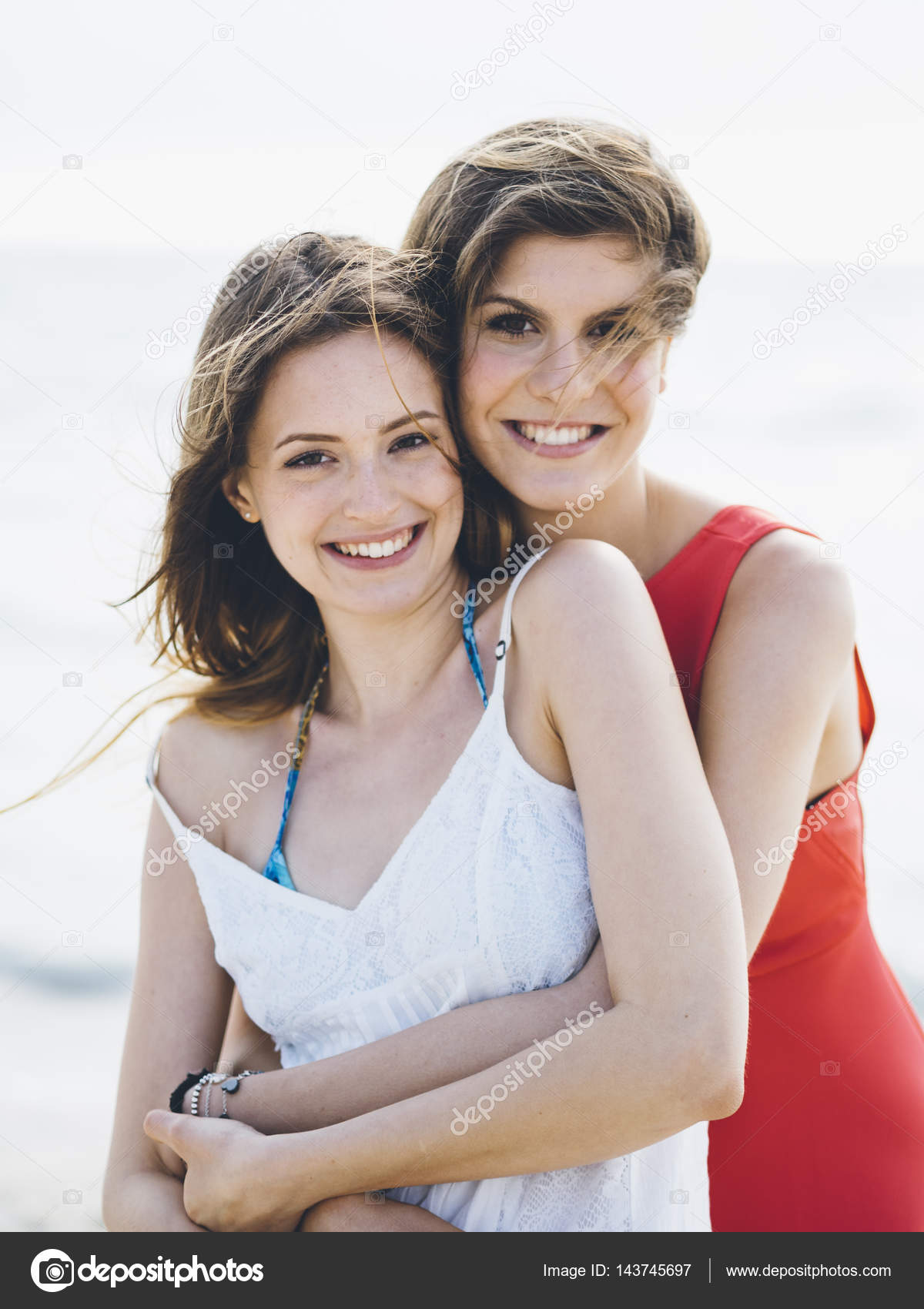 Young women hugging Stock Photo by ©juripozzi 143745697
