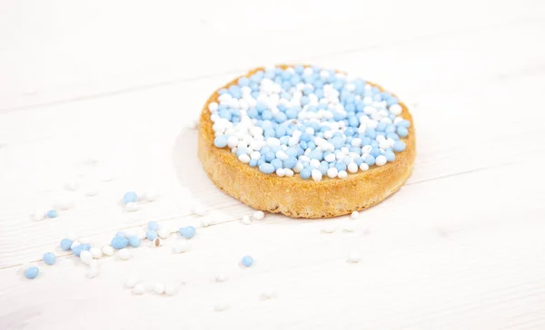 Traditional Dutch birth celebration biscuit with pink muisjes on wooden ...
