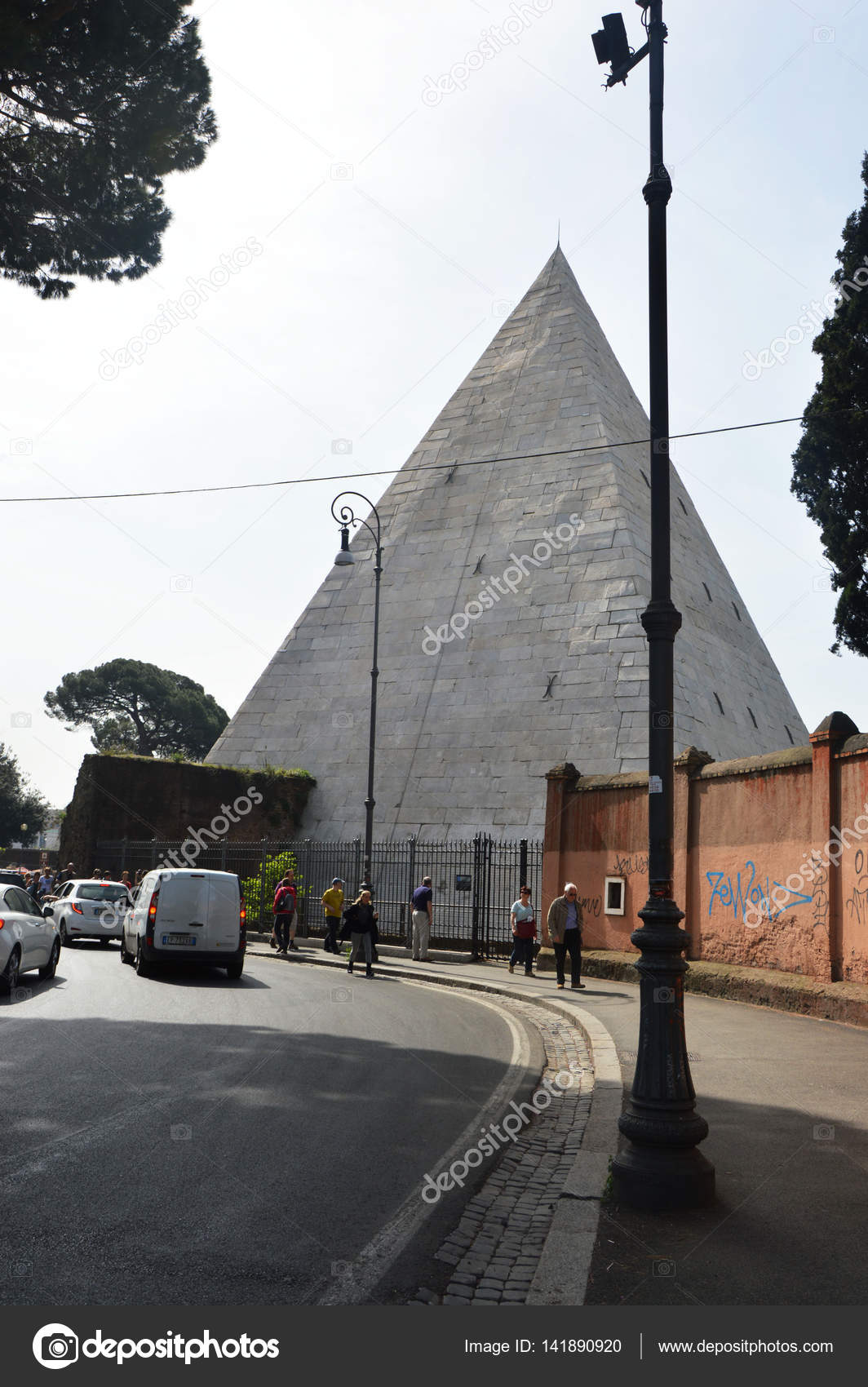 View on the Pyramid of Cestius, in spring day with tourists and car ...