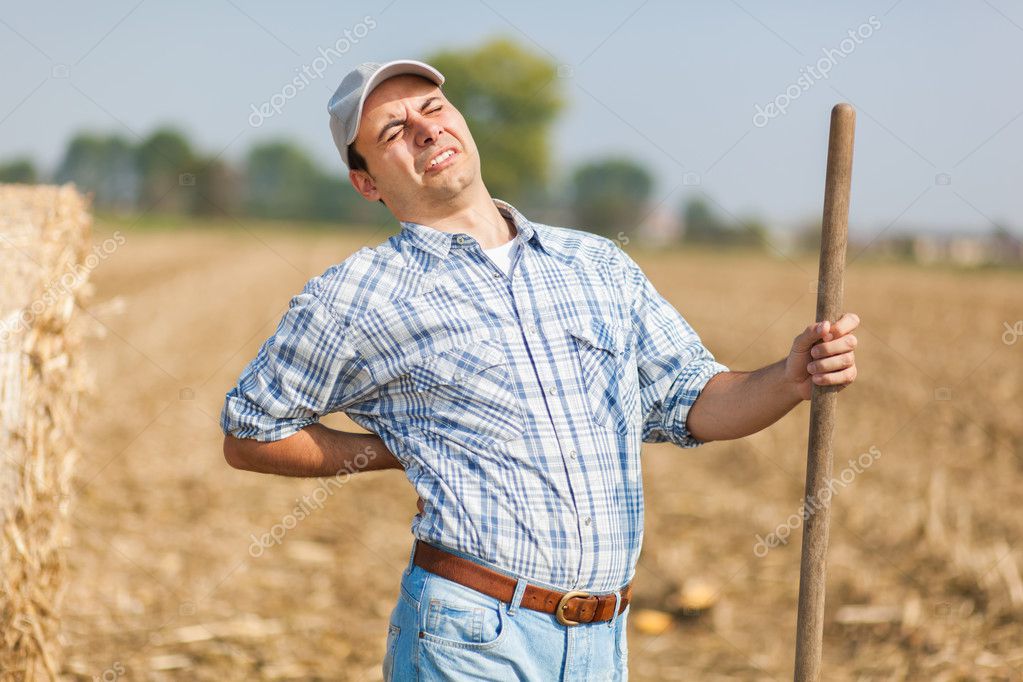 Farmer having back pain — Stock Photo © minervastock #127921278
