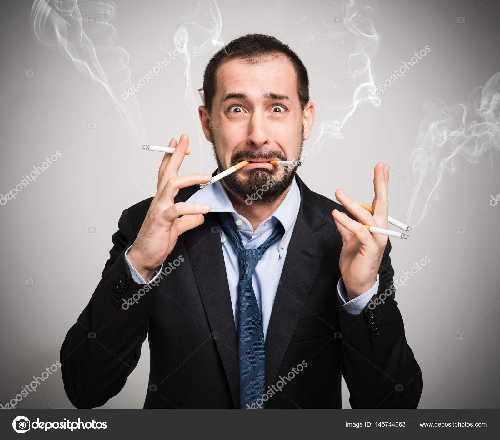 Nervous man smoking a lot of cigarettes — Stock Photo © minervastock ...