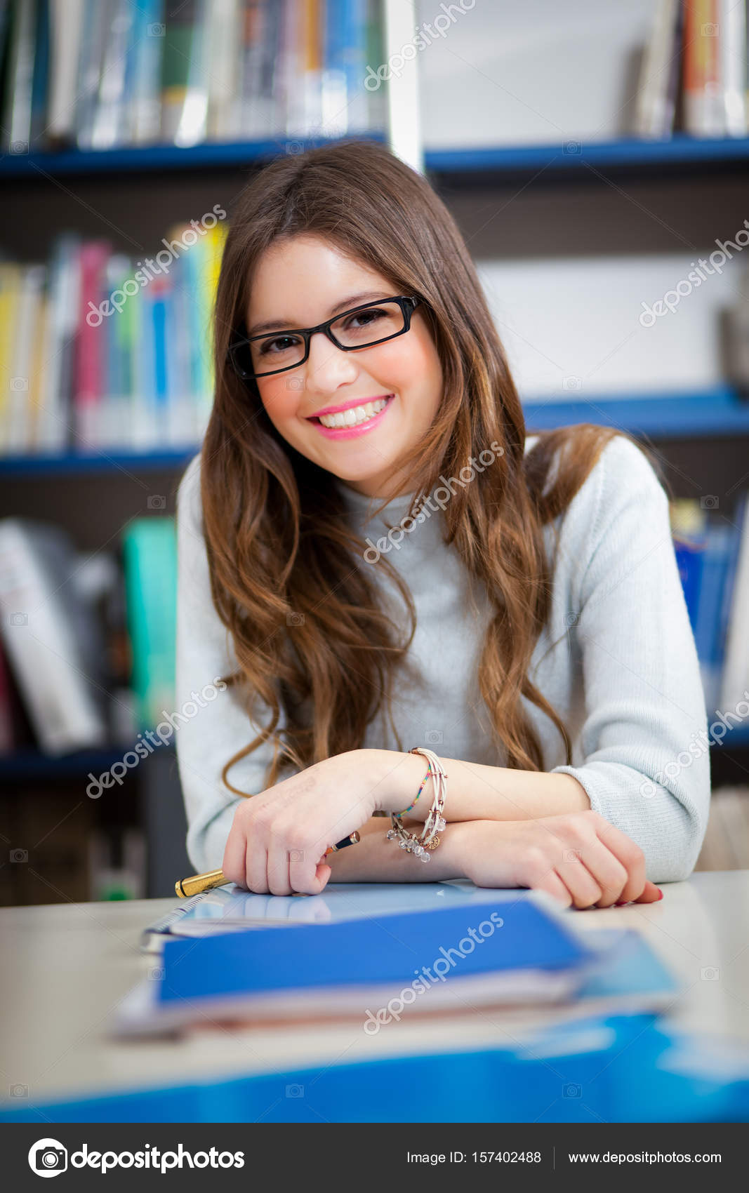 Female student smiling in a Library — Stock Photo © minervastock #157402488