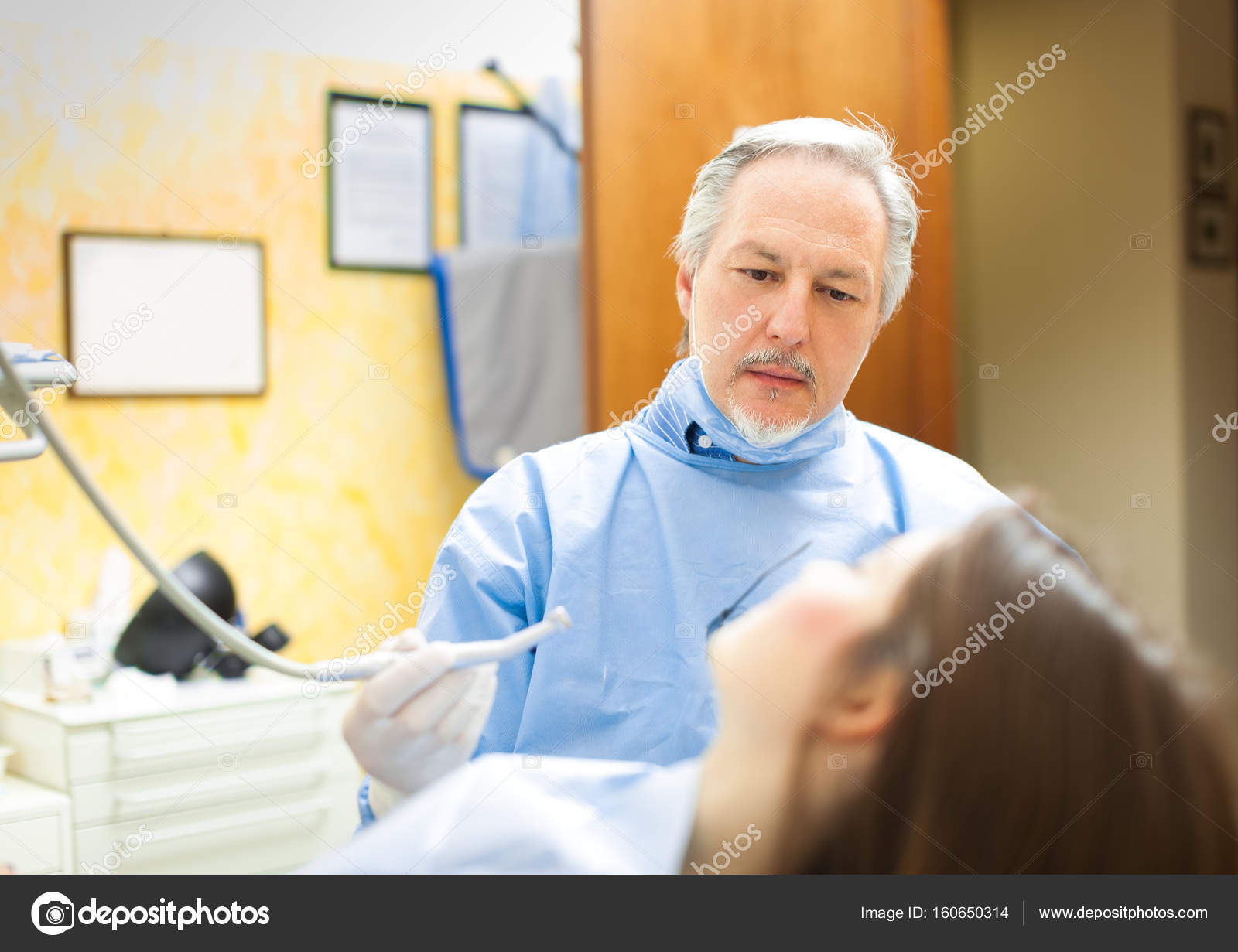 Dentist curing female patient Stock Photo by ©minervastock 160650314