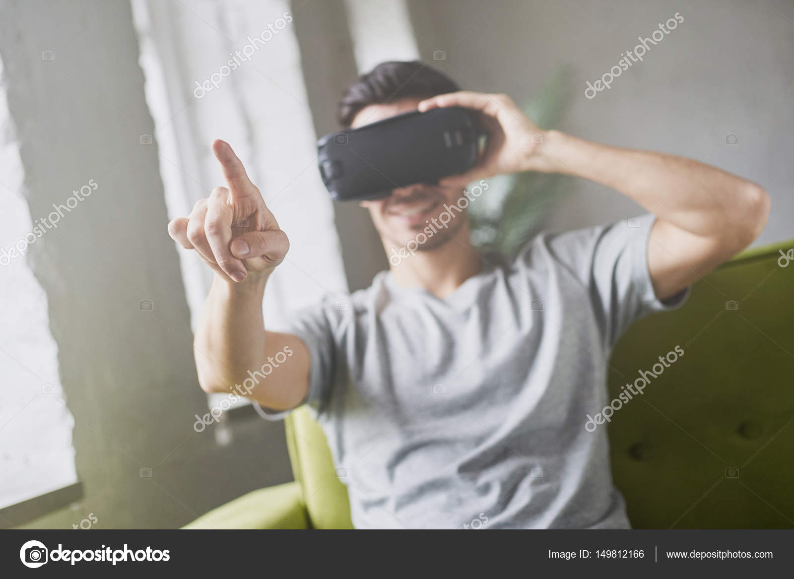 One man using oculus rift headset, experiencing virtual reality while ...