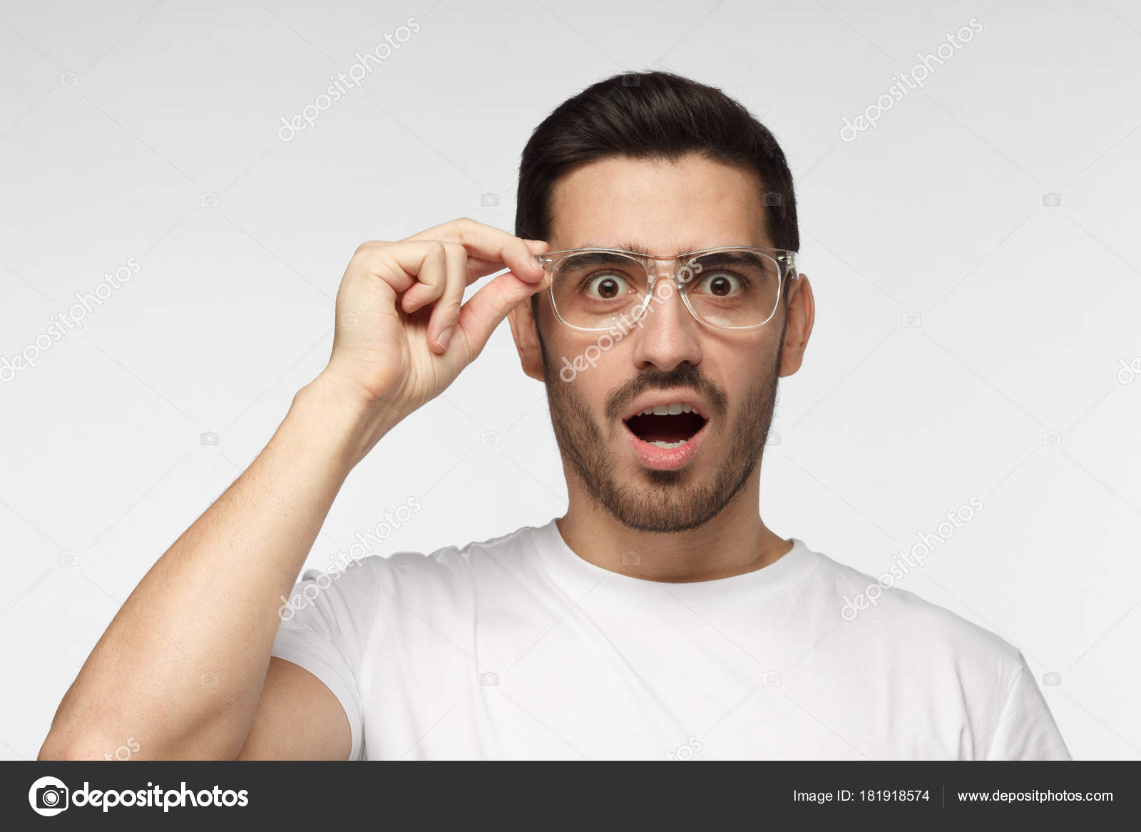 Casual dressed young man in white t-shirt shouting oh my god with open ...