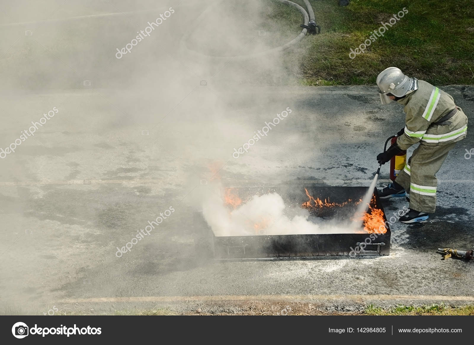Firefighter using fire extinguisher — Stock Photo © VAKSMANV101 #142984805