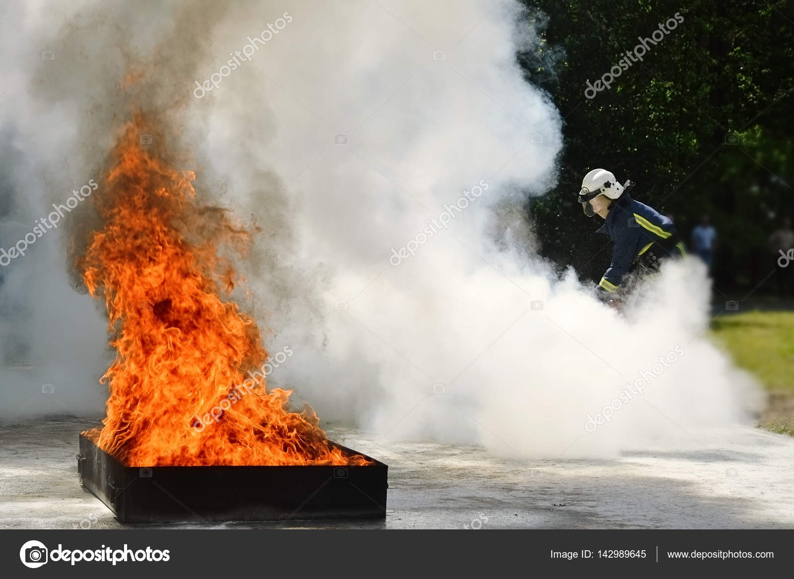 Firefighter using fire extinguisher — Stock Editorial Photo ...
