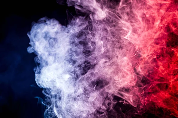 Colorful red and blue smoke clouds on dark background.Background of ...