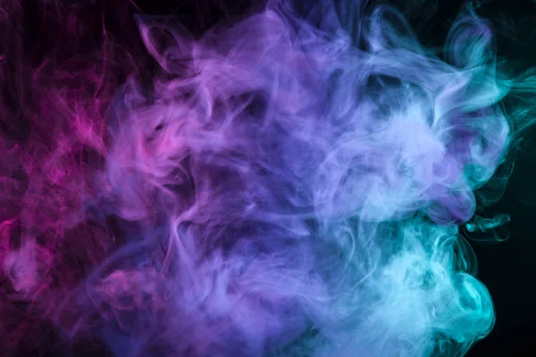 Pink, blue and red cloud of smoke of black isolated background ...
