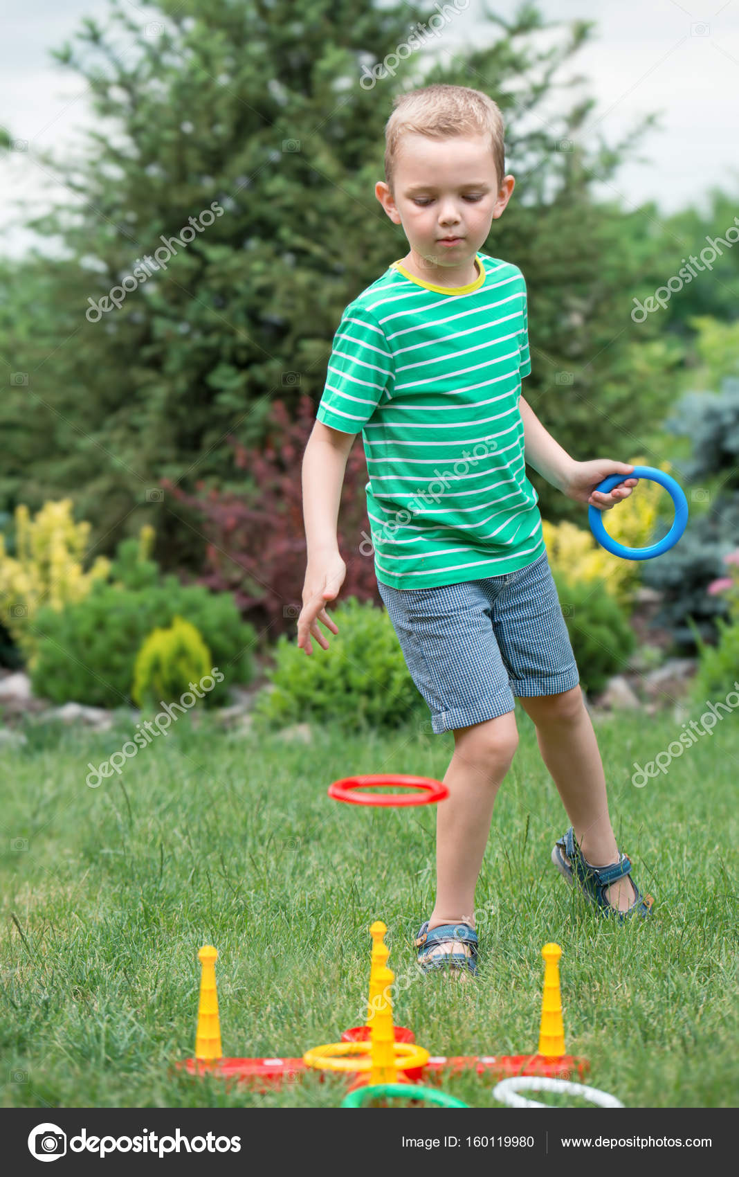 Boy playing a game throwing rings outdoors in summer Park Stock Photo ...