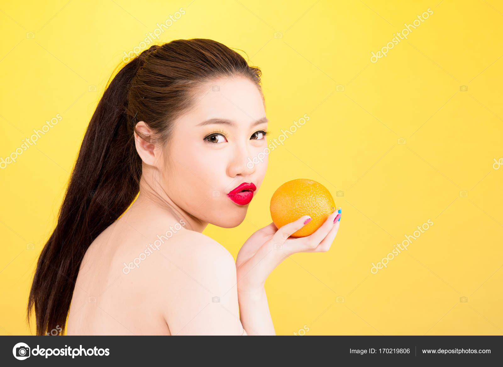Young Asian woman kissing orange isolated in yellow background. — Stock ... Young Asian woman kissing orange isolated in yellow background. — Stock ...