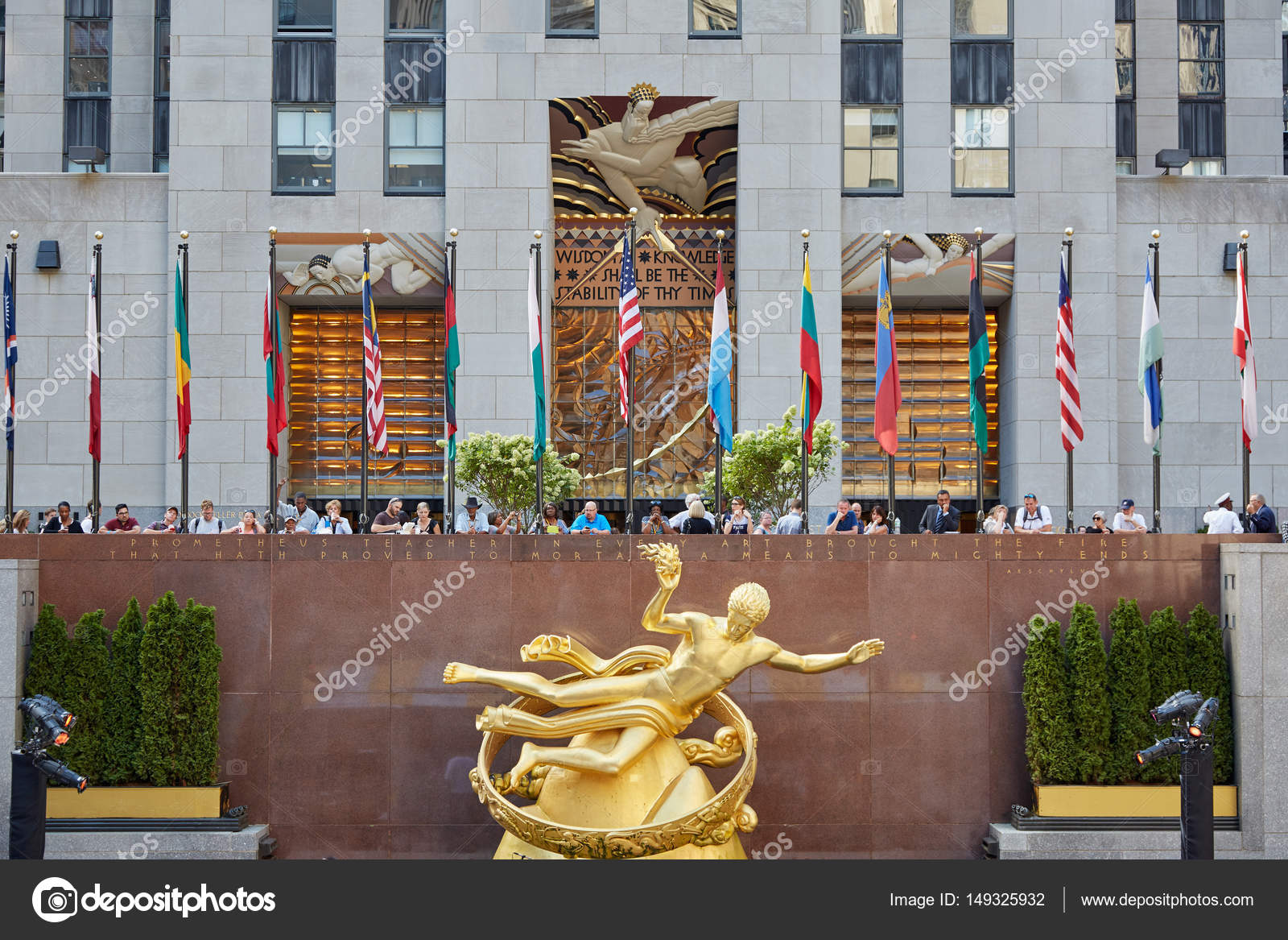 Rockefeller Center with golden Prometheus statue and people in New York ...