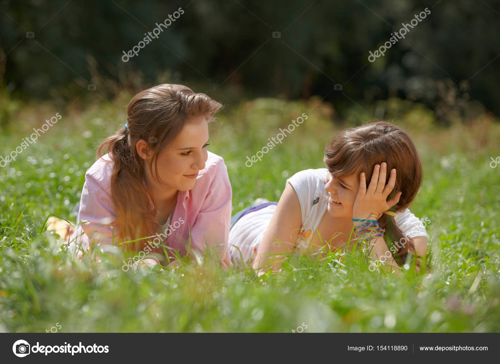 Two girls having fun together in a park Stock Photo by ©ImageSource ...