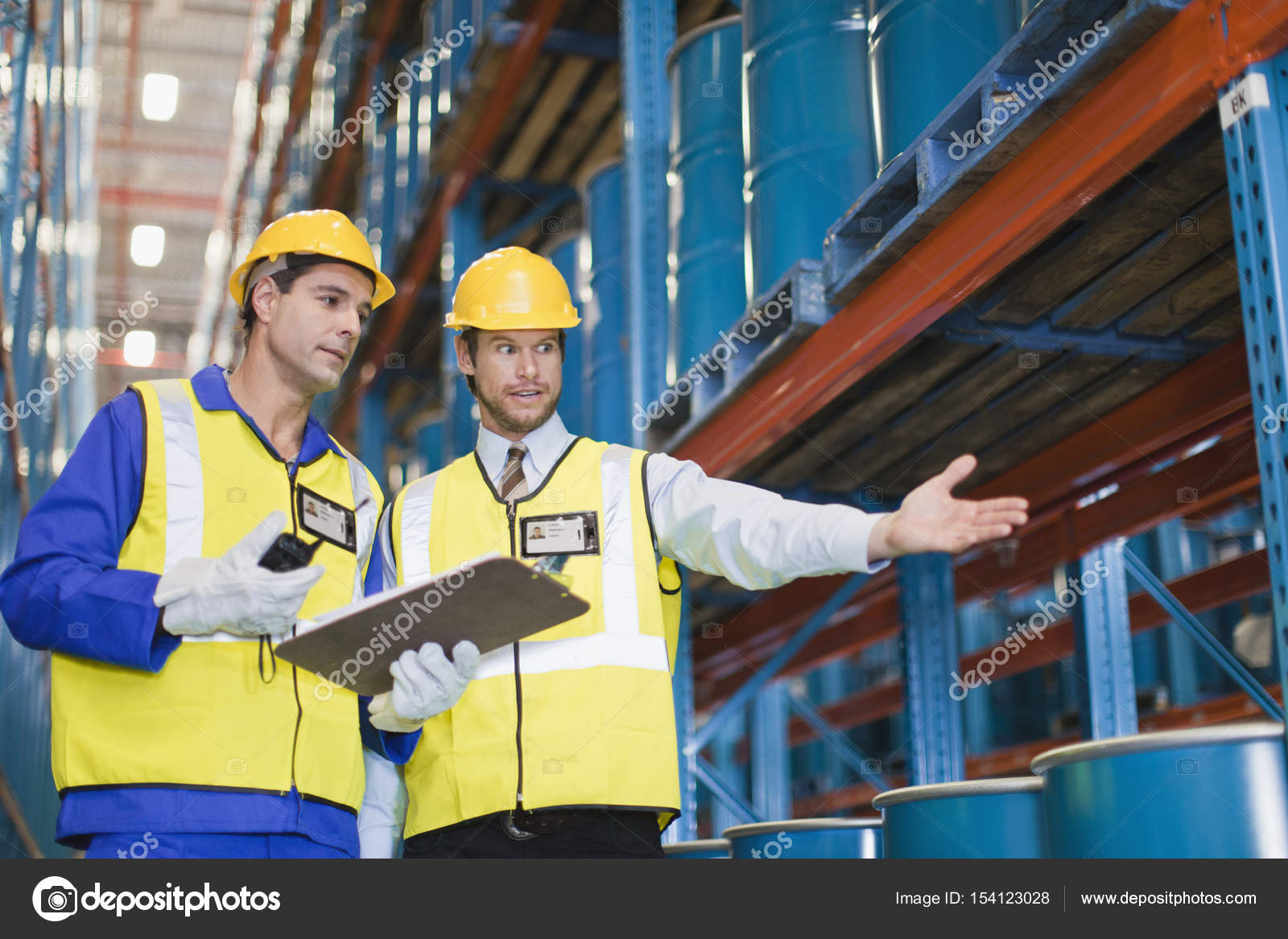 Workers pointing on containers — Stock Photo © ImageSource #154123028