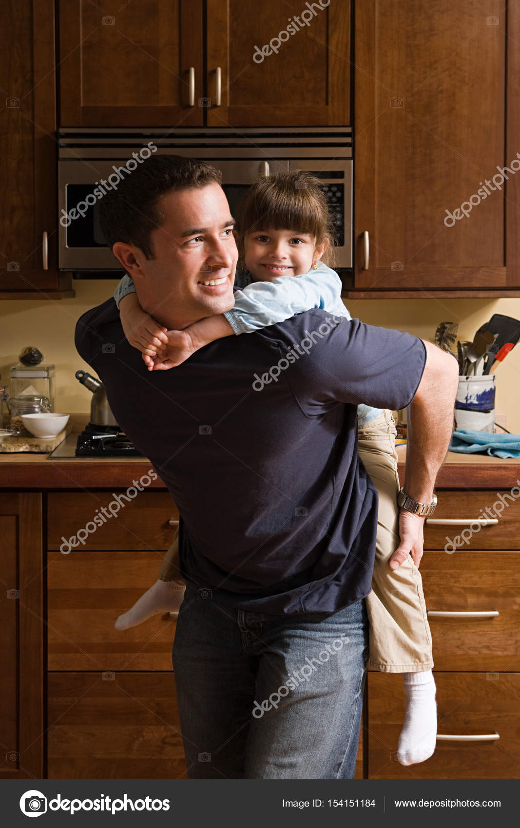 Father giving daughter piggyback ride Stock Photo by ©ImageSource 154151184
