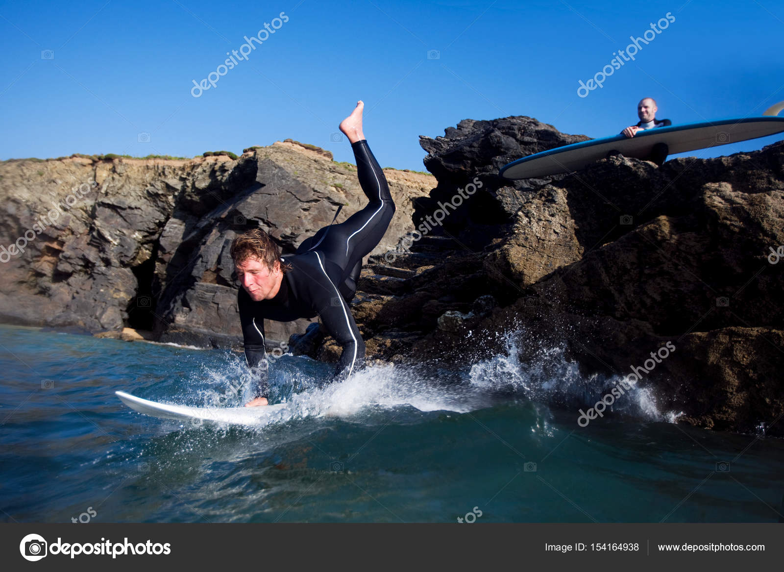Man jumping onto surfboard — Stock Photo © ImageSource #154164938