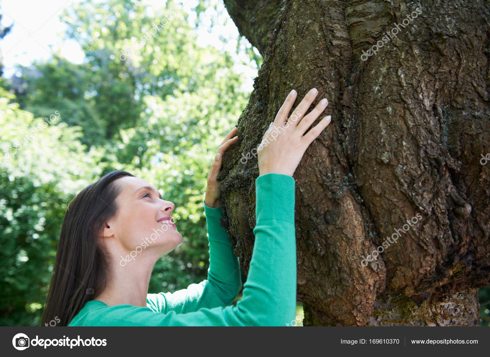 Smiling Woman Hugging Tree Stock Photo by ©ImageSource 169610370