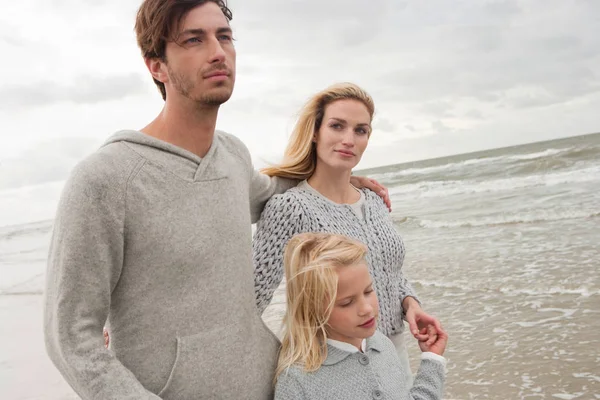 Family walking on windy beach Stock Photo by ©ImageSource 171728922
