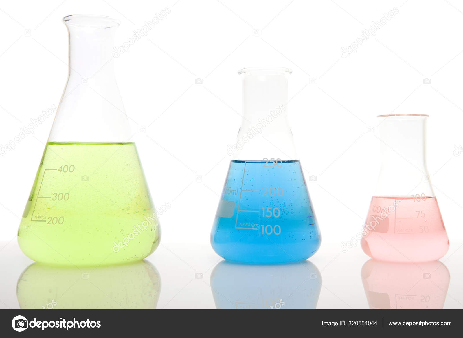 Three volumetric flasks in a row — Stock Photo © ImageSource #320554044