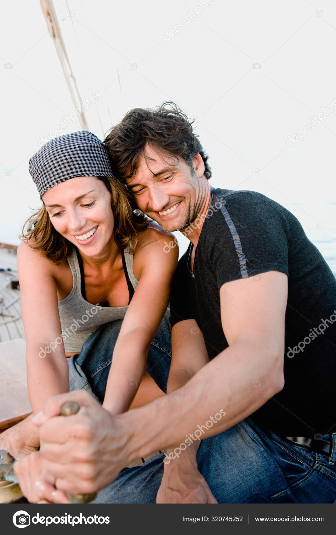 Couple Tying Ropes Deck — Stock Photo © ImageSource #320745252