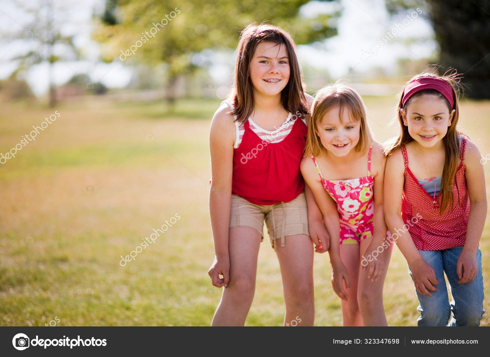 Young Girls Standing Line Laughing Stock Photo by ©ImageSource 323347698