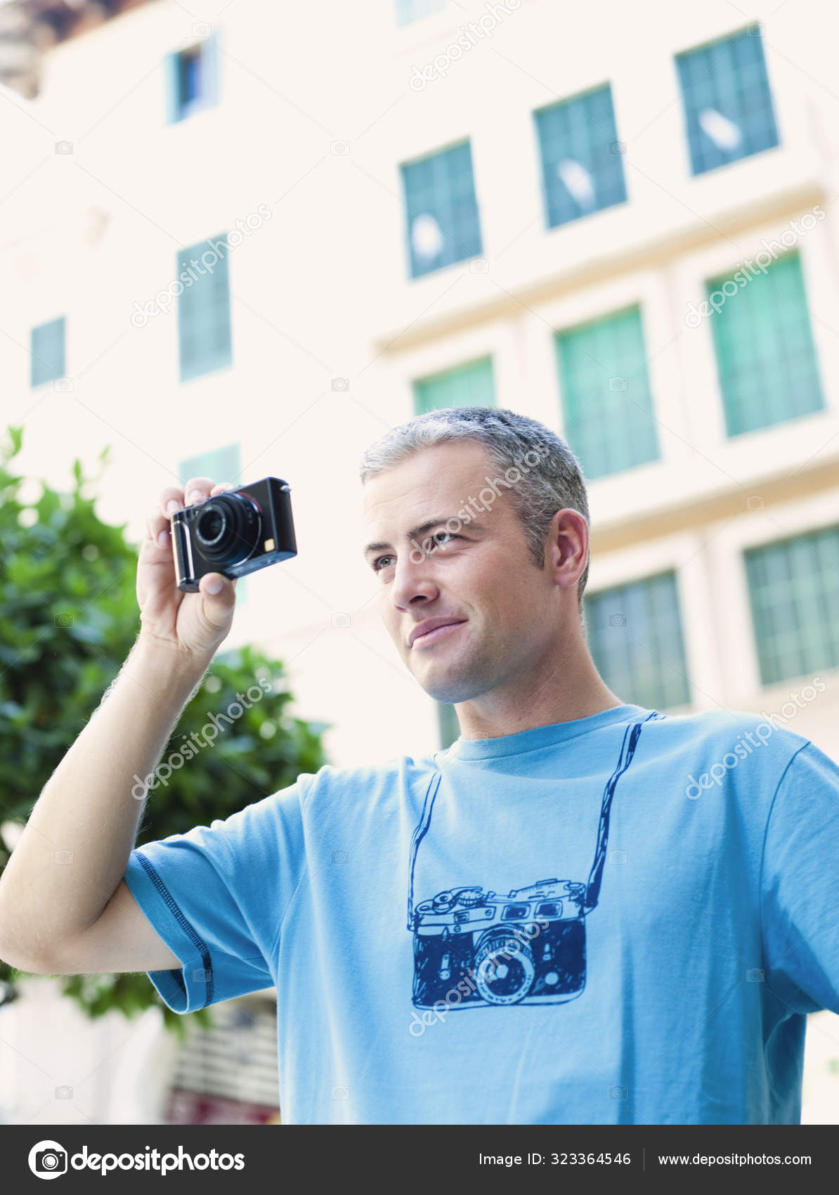 Man Using Camera Building — Stock Photo © ImageSource #323364546