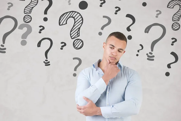 Man wondering with question marks around him - Stock Image - Everypixel