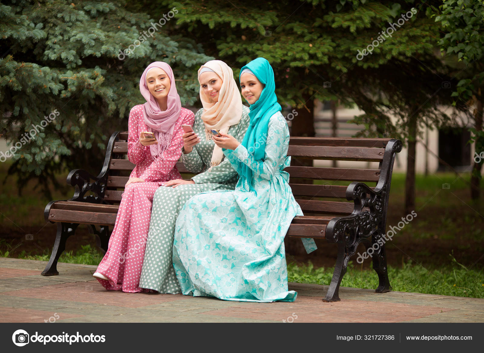 Three Beautiful Young Women Muslim Dresses Summer Park Phones Hands ...