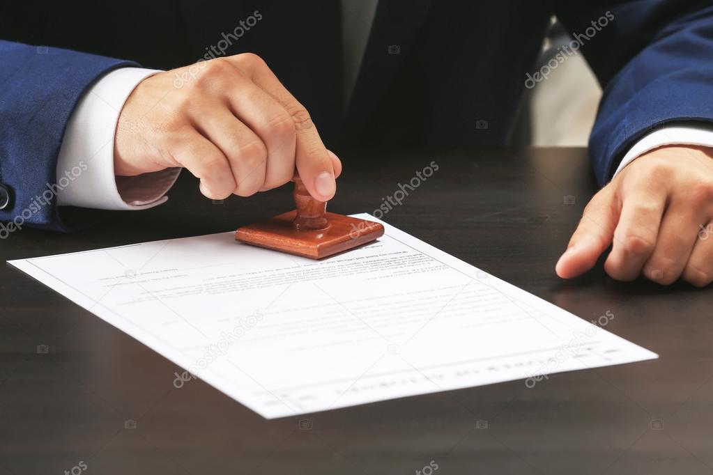 Notary public in office stamping document — Stock Photo © belchonock ...