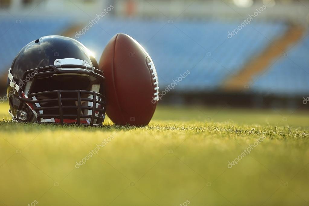 Rugby helmet with ball on field — Stock Photo © belchonock #126258462