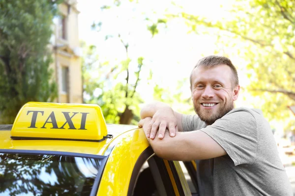 Handsome taxi driver Stock Photo by ©belchonock 126325910