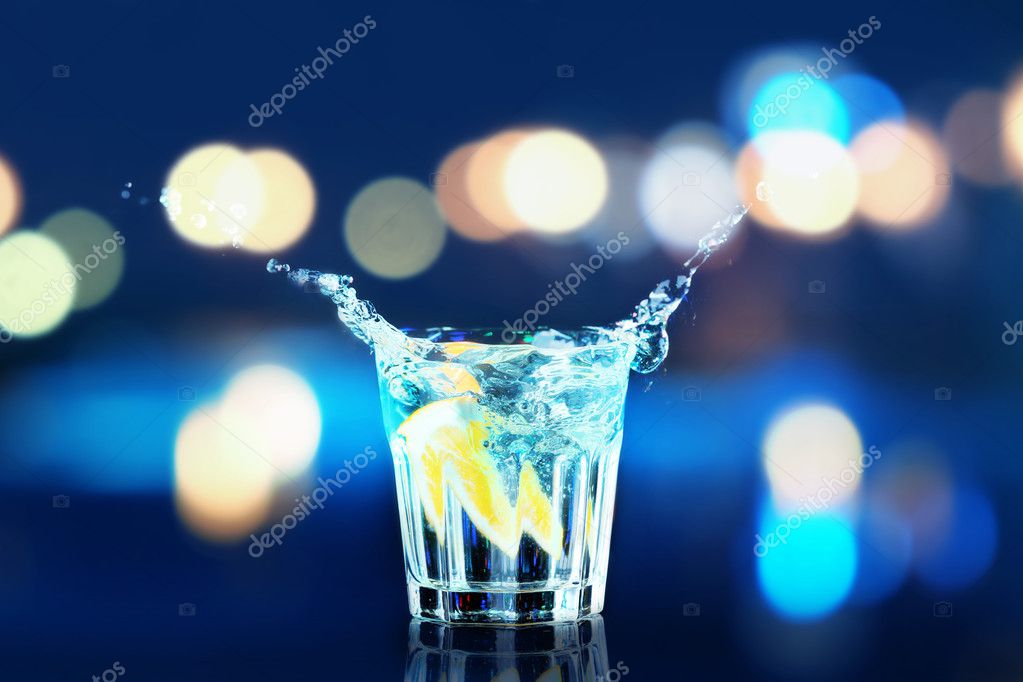Colorful cocktail with splash on lights background — Stock Photo ...