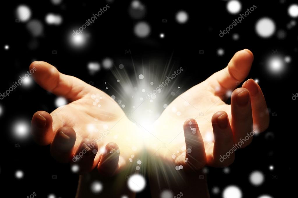 Female hands holding light in dark, closeup. Snowy effect, Christmas ... Female hands holding light in dark, closeup. Snowy effect, Christmas ...