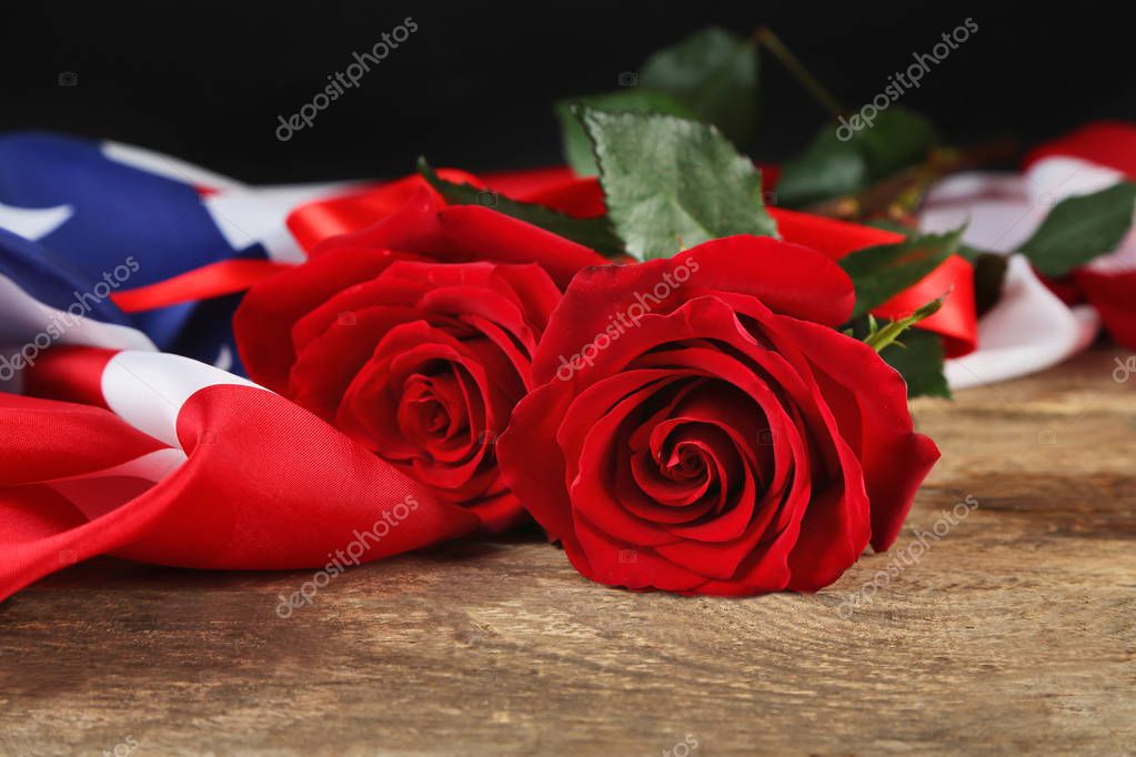 Red roses on American flag, closeup — Stock Photo © belchonock #129173804