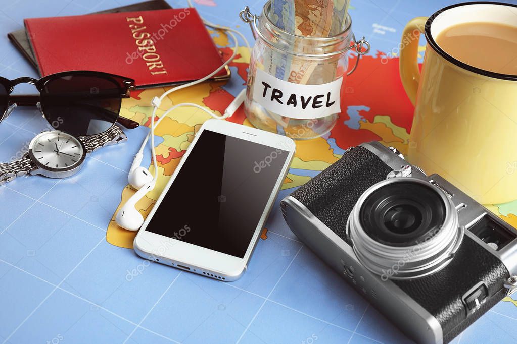 Traveller's accessories on world map background. Travel planning ...