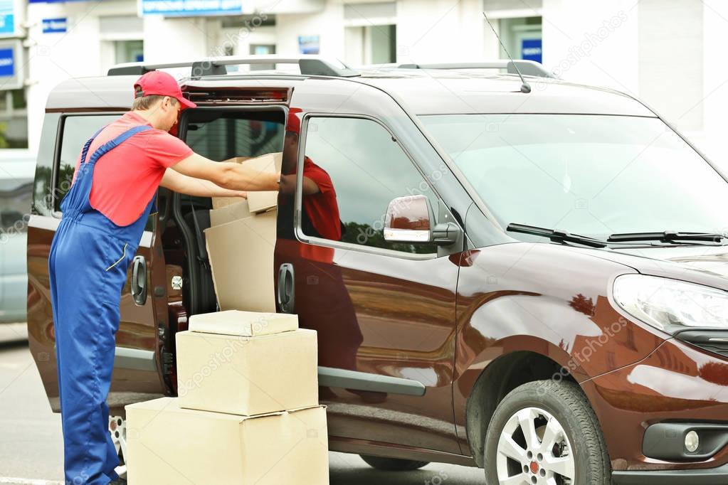 Delivery concept. Postman with car — Stock Photo © belchonock #130396056