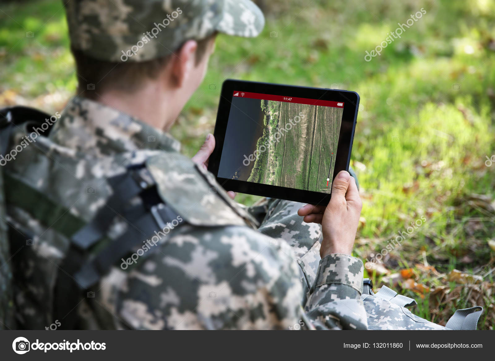 Soldier using map on tablet for orientation at forest — Stock Photo ...