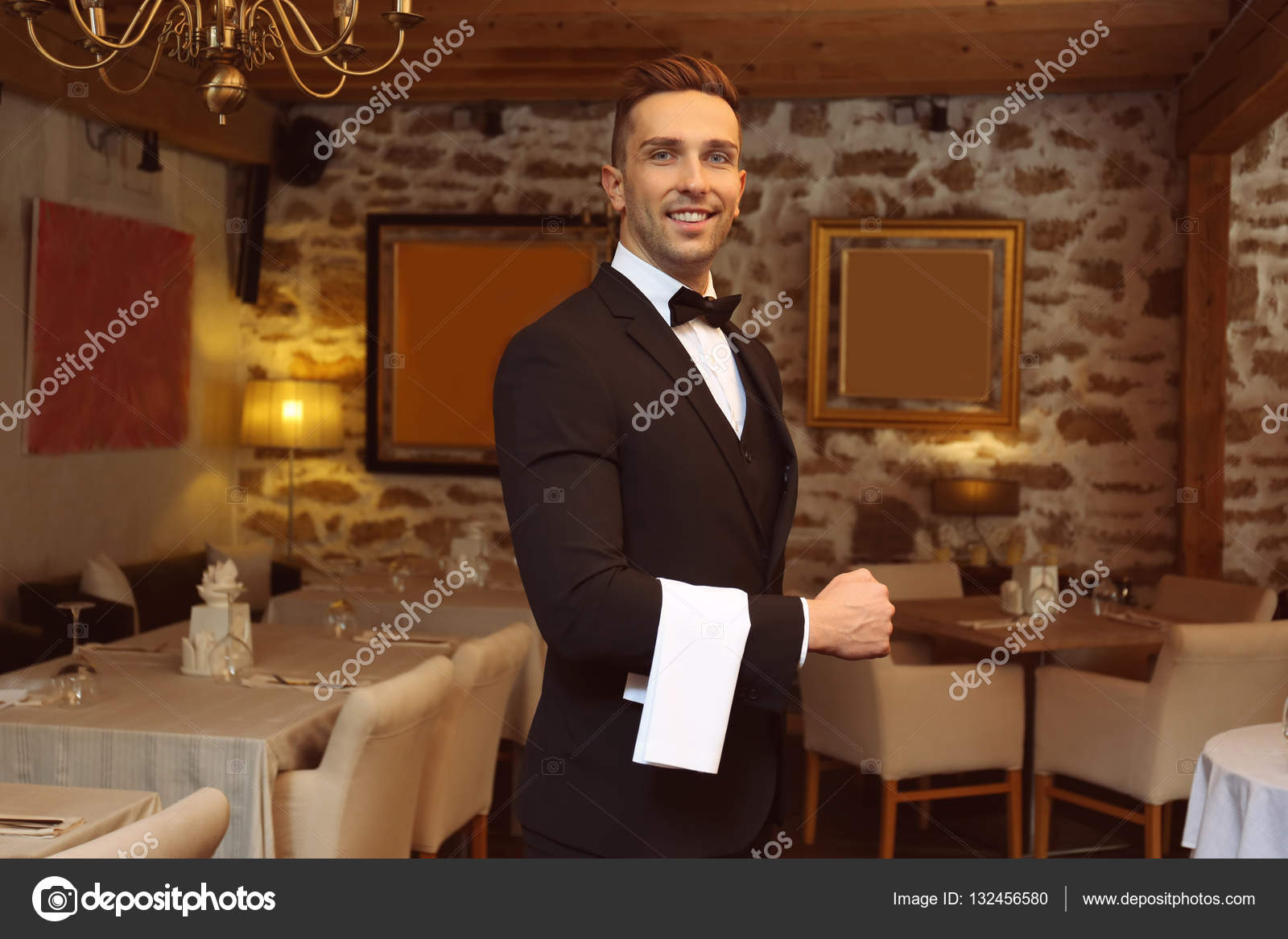 Handsome young waiter Stock Photo by ©belchonock 132456580