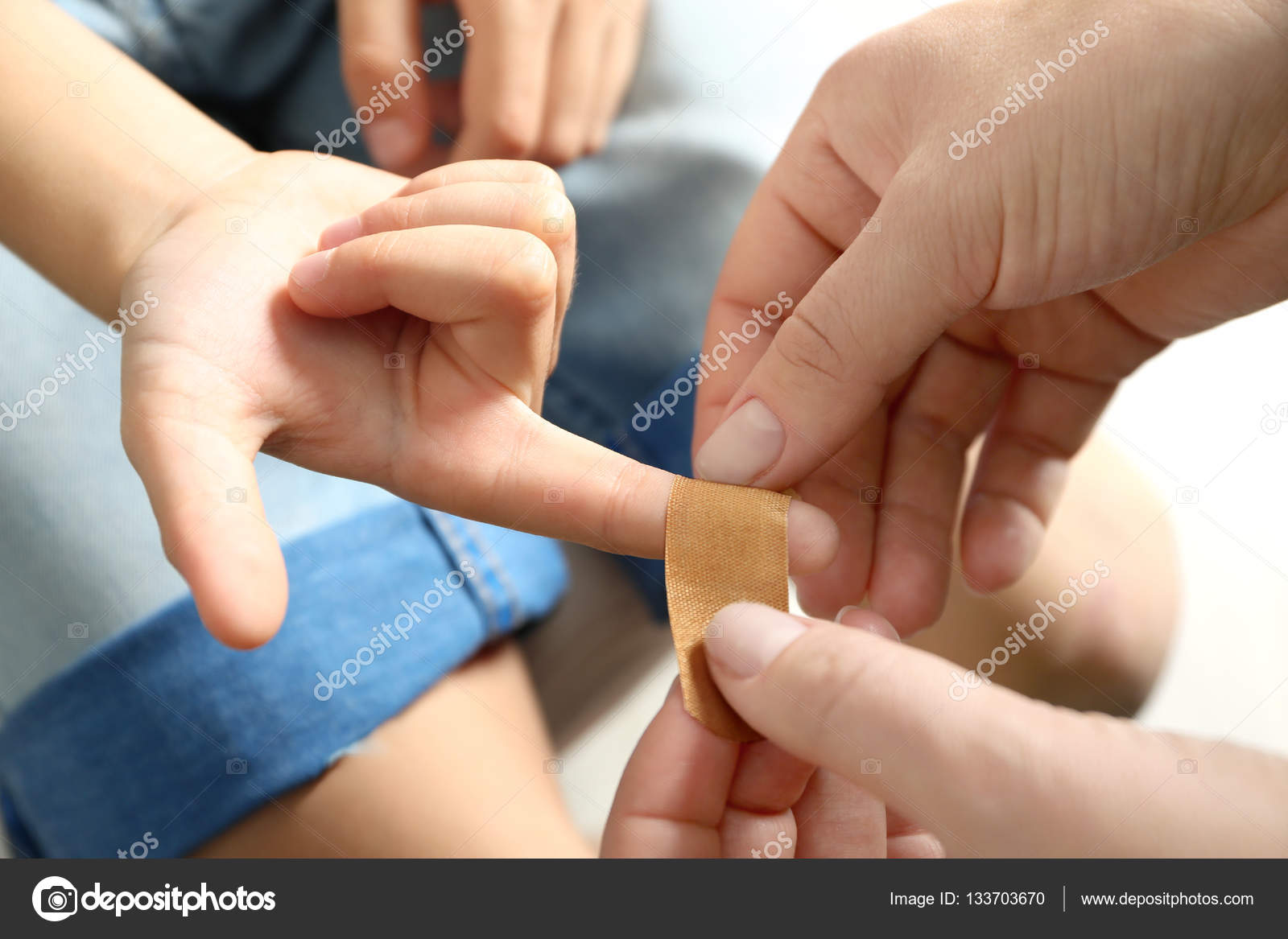 Woman wrapping sticking plaster Stock Photo by ©belchonock 133703670